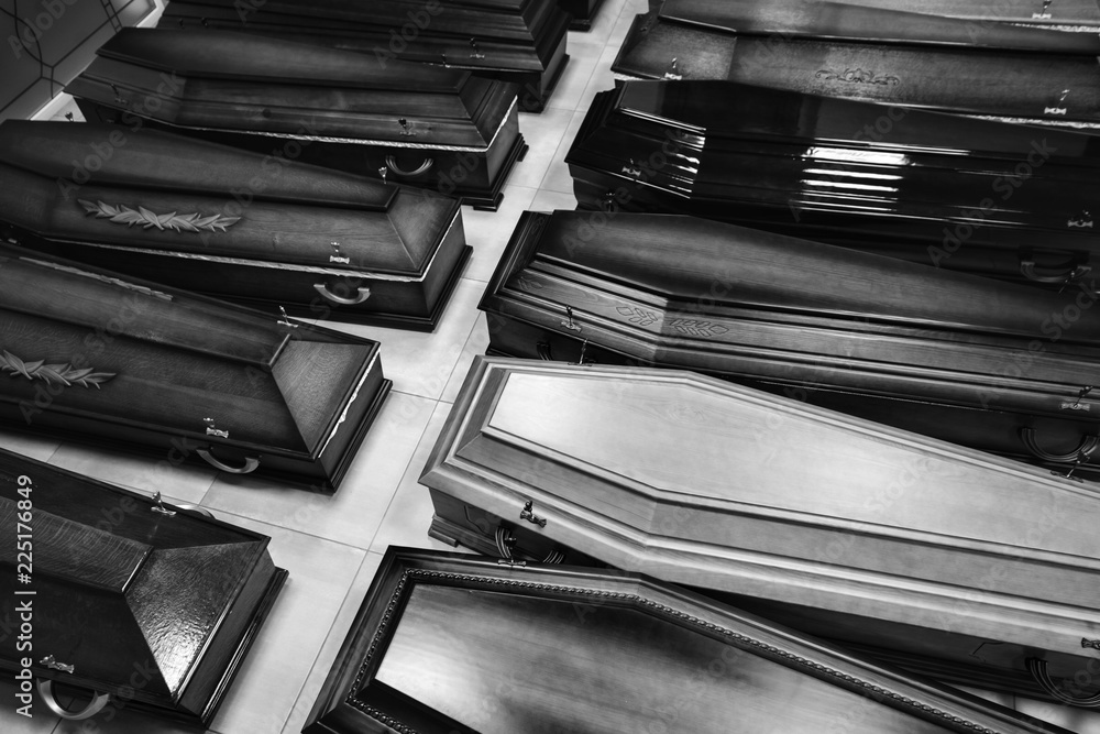Black and white photo of wooden coffins. Funeral business background ...