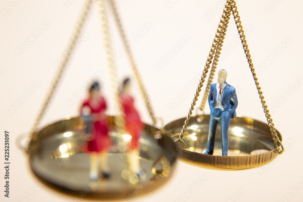 Depicted in a conceptual image by a seesaw showing the male and female ...