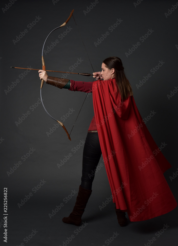 full length portrait of brunette girl wearing red medieval costume and ...