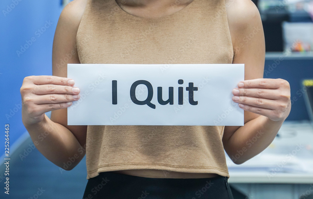 businesswoman hold I quit as a resignation letter with both hands in ...