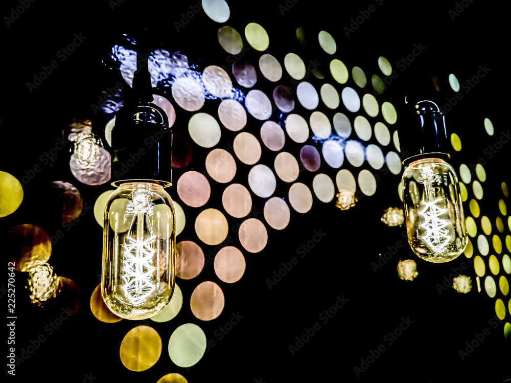 Tungsten orange light bulb hanging on the inside of the building with a ...