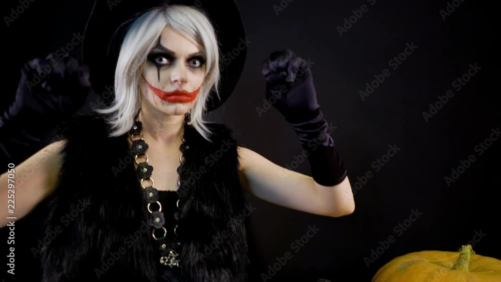 Scary beautiful girl witch celebrates halloween with funny glowing ...