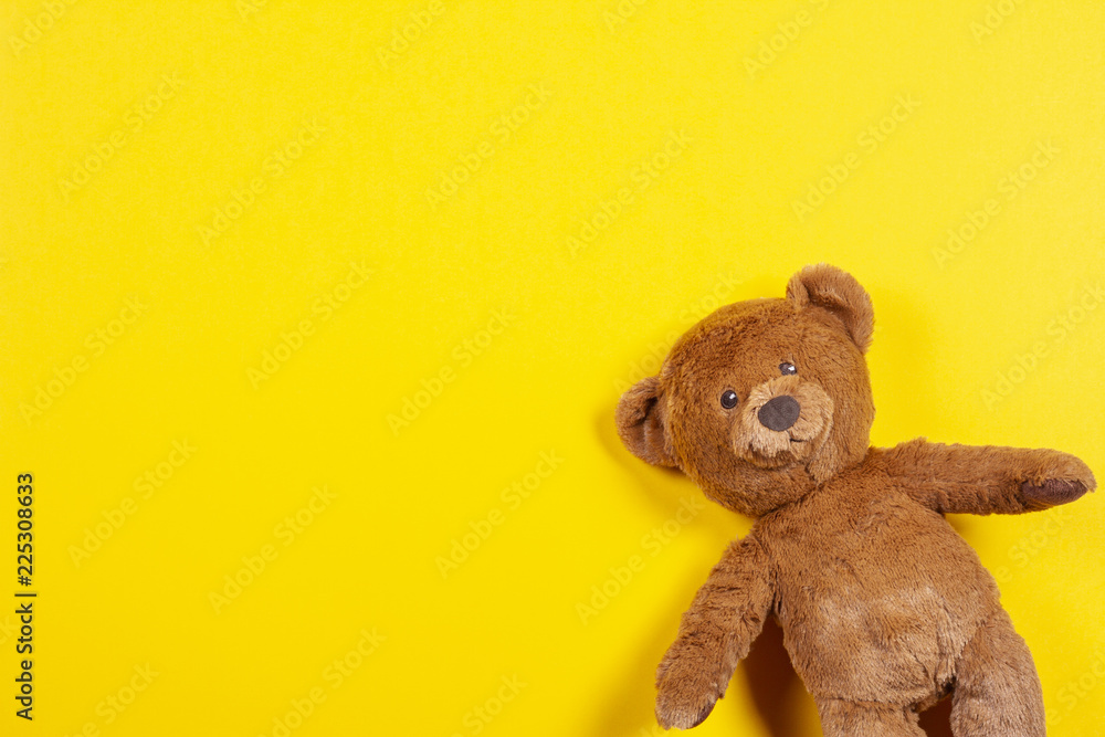 Teddy bear toy on yellow background. Top view Stock Photo | Adobe Stock