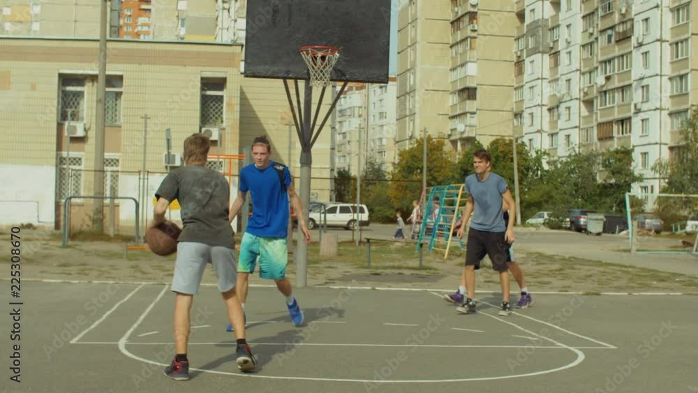Teenage friends having fun and playing streetball game on outdoor ...