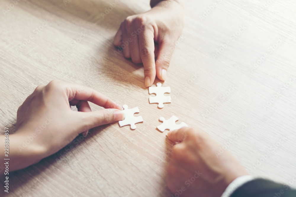 team hand power full man and woman placing the jigsaw puzzle piece for ...