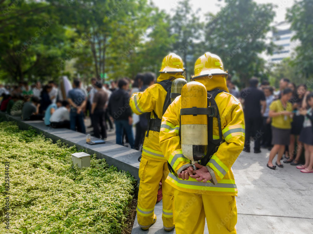 Select focus of back Firefighters in yellow suit with an oxygen tank in ...