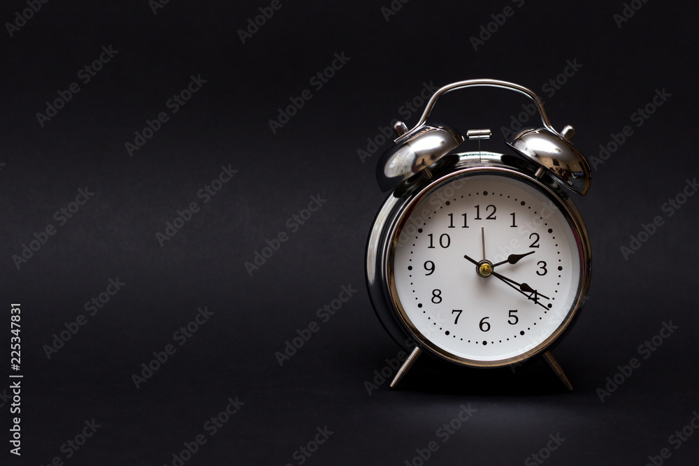 black retro alarm clock in dark background.For time concept. Stock ...