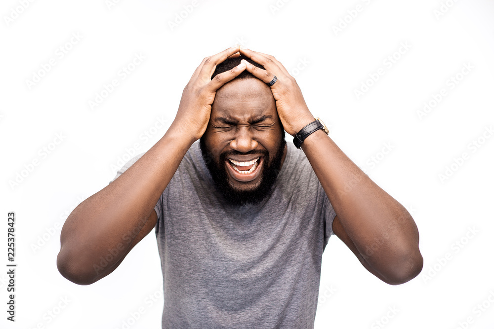 Emotional African American male closes eyes, despair, opens mouth ...