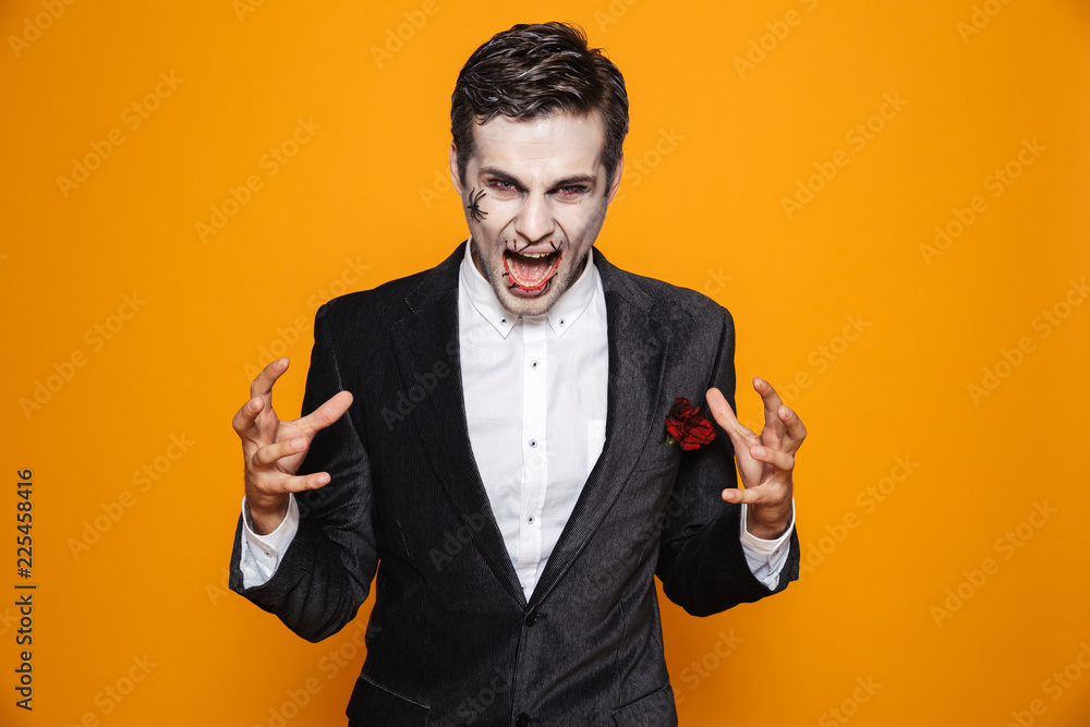 Angry psycho man zombie screaming isolated over orange Stock Photo ...