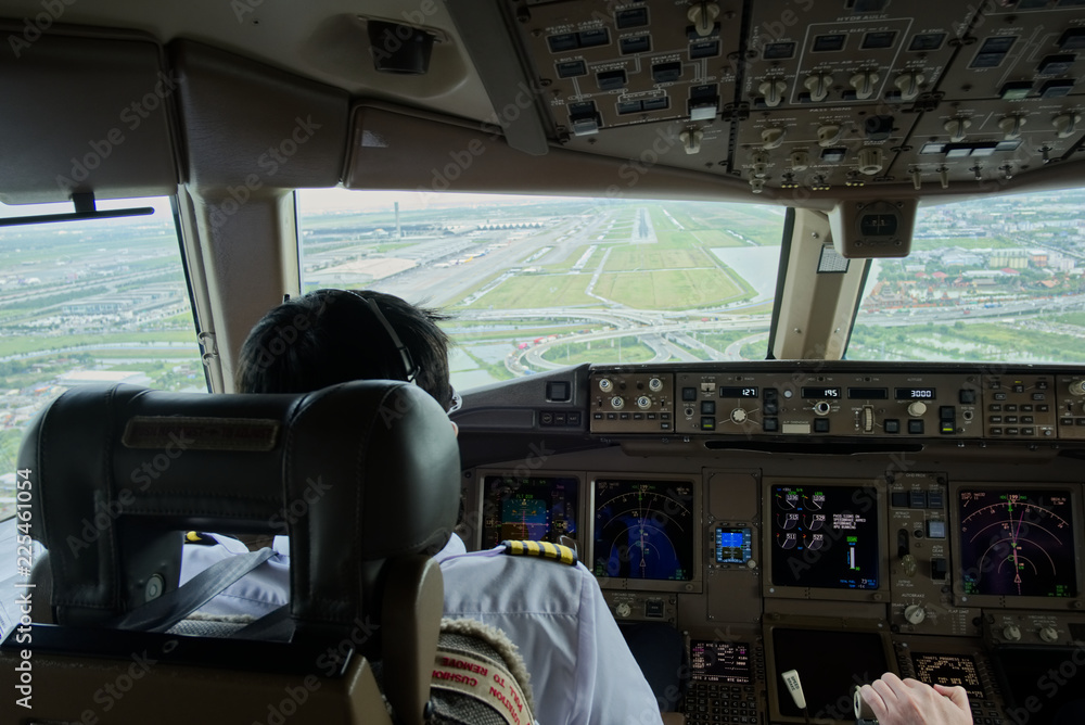 View from captain seat. Pilots are controlling the airplane towards the ...