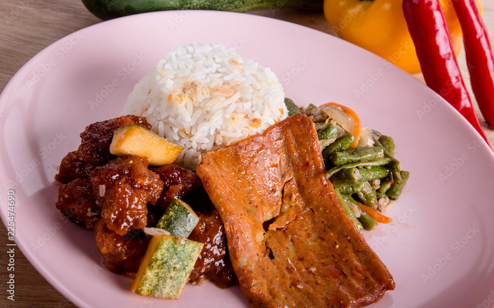 Plate of steamed rice served with various dishes for a simple, economic ...