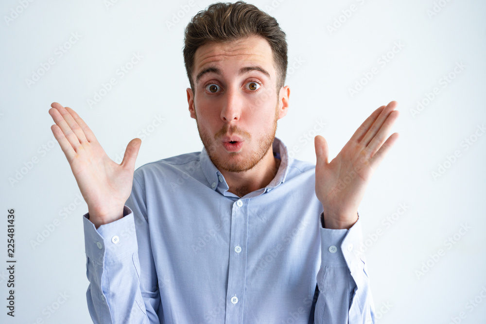 Amazed businessman extremely shocked and surprised with news. Young man ...