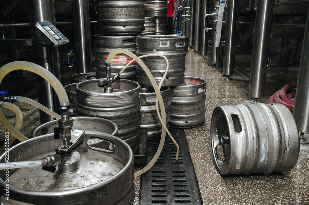 Steel industrial stack of beer kegs against. Stock Photo | Adobe Stock