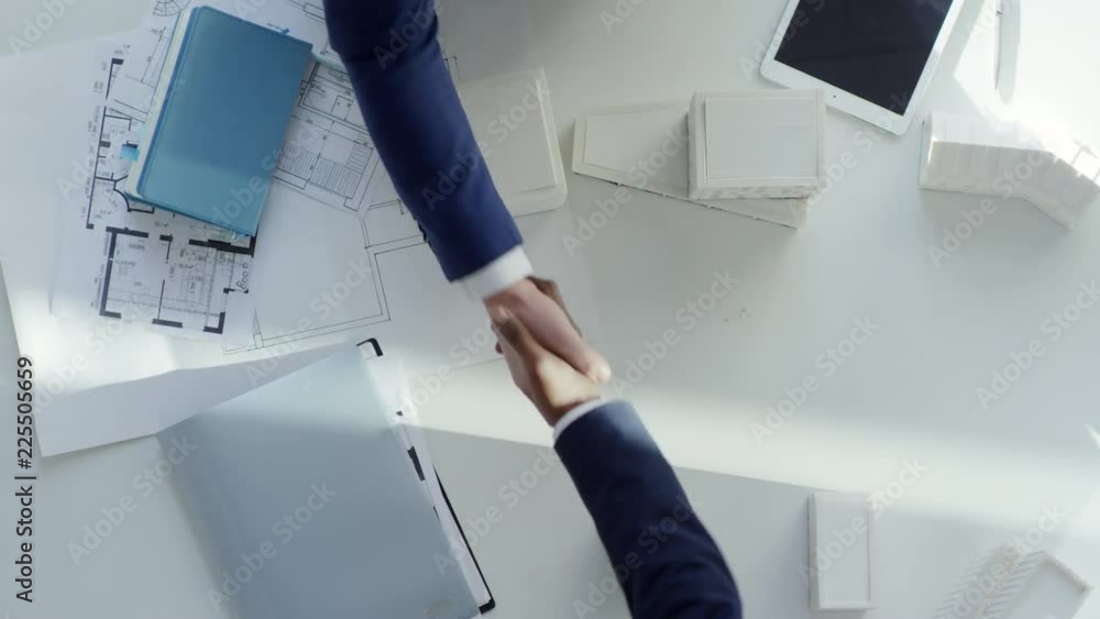 Top view of two unrecognizable male entrepreneurs of different ...