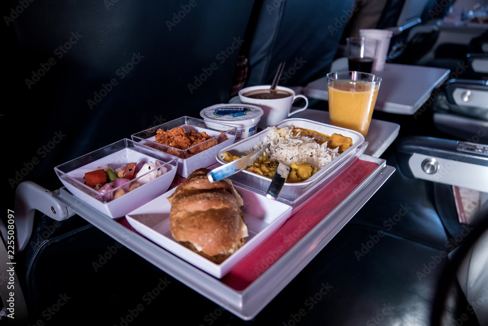 Tray of food. The passenger eats food on Board the plane on the ...