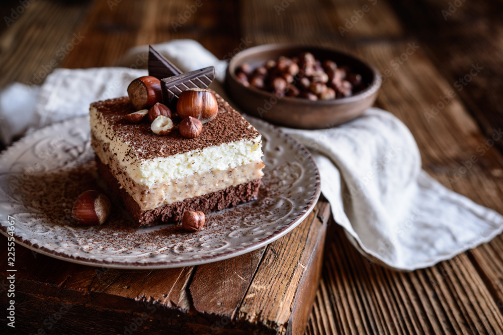 Chocolate sponge cake with hazelnut and whipped cream layers, topped ...