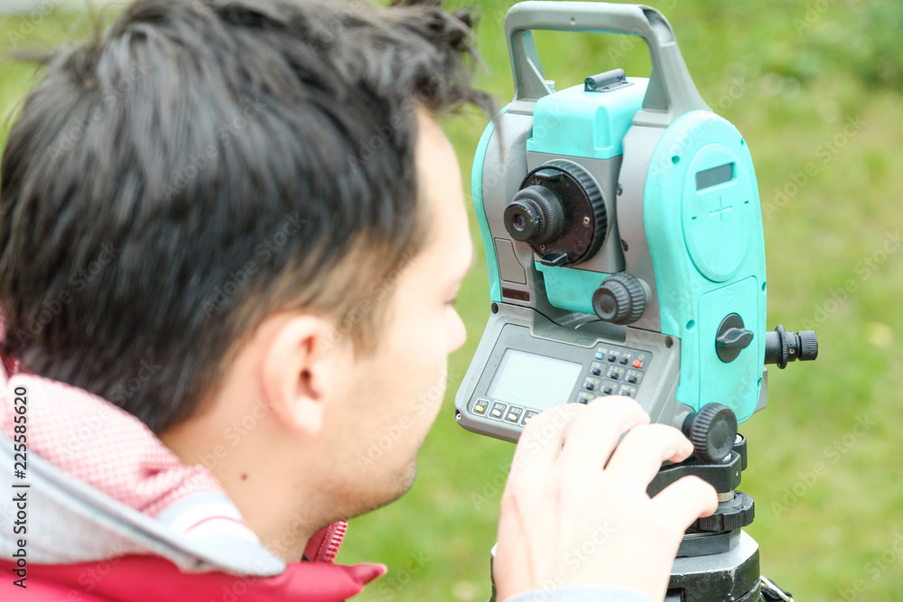 Civil engineer land survey with tacheometer or theodolite equipment ...