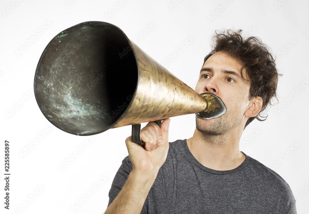 Young man using an old megaphone Stock Photo | Adobe Stock