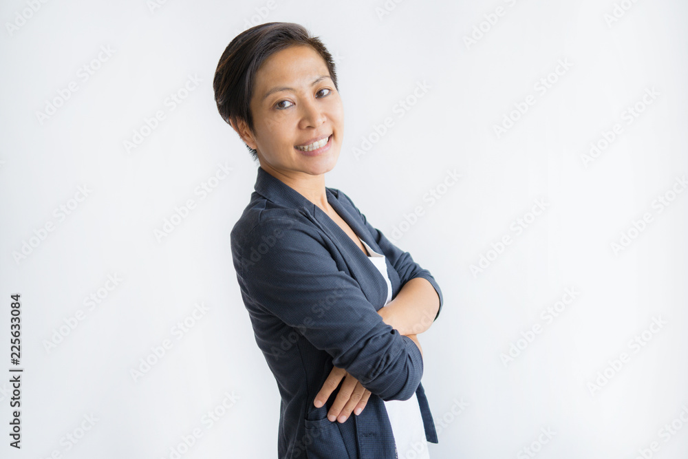 Positive Asian business woman looking at camera. Young lady standing ...