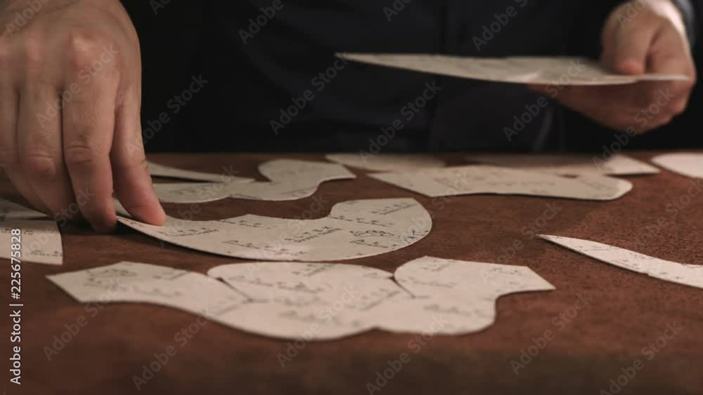 Close up of a cobbler stitching a part of the shoe at a workshop ...
