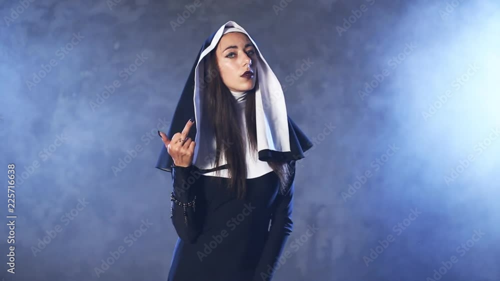 Nun shows the middle finger of the hand Stock Video | Adobe Stock