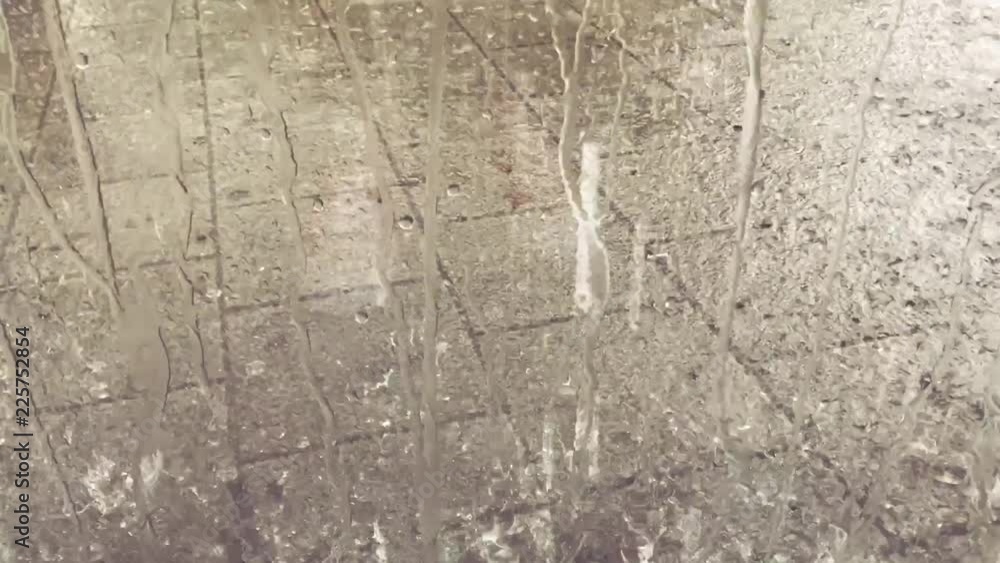 Rain falling on an urban pavement Stock Video | Adobe Stock