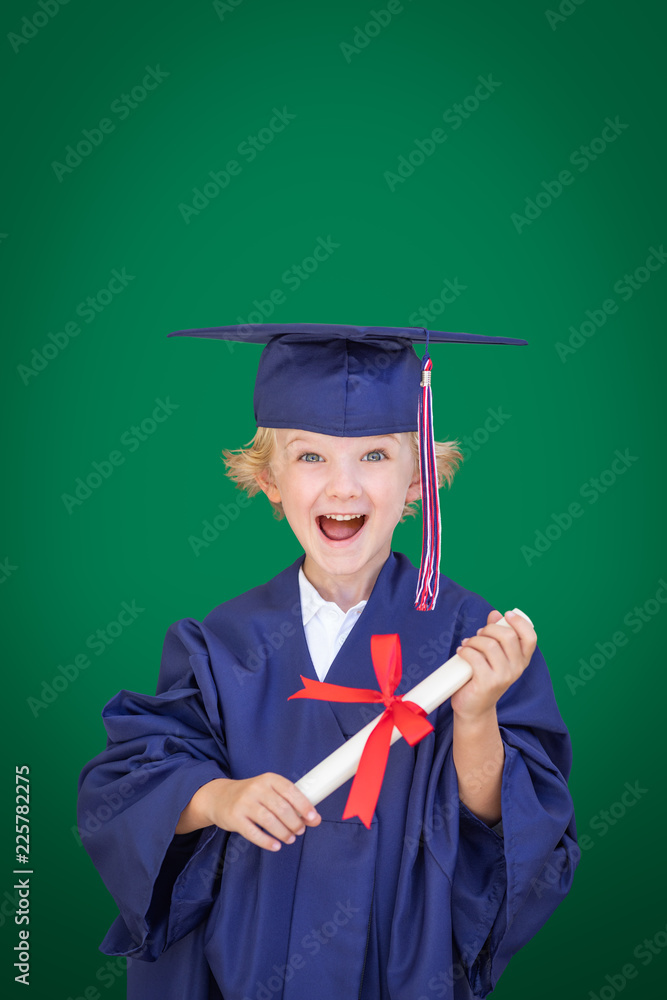 Cute Young Caucasian Boy Wearing Graduation Cap and Gown Against Blank ...
