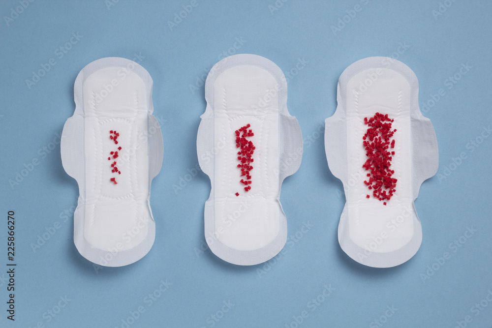 Concept periods. Hygienic pads with red dots on a blue background ...