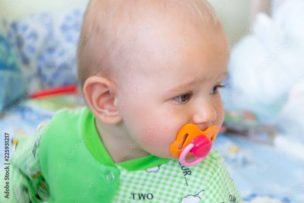 One year old baby nibbles / sucks on a rubber nipple because his teeth ...