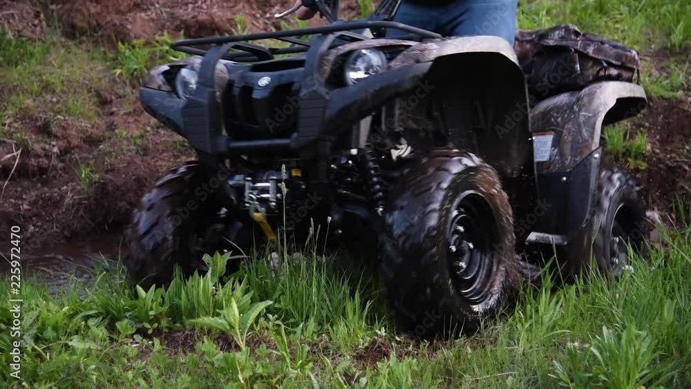 An ATV driving through a muddy ditch in slow motion. Stock Video ...