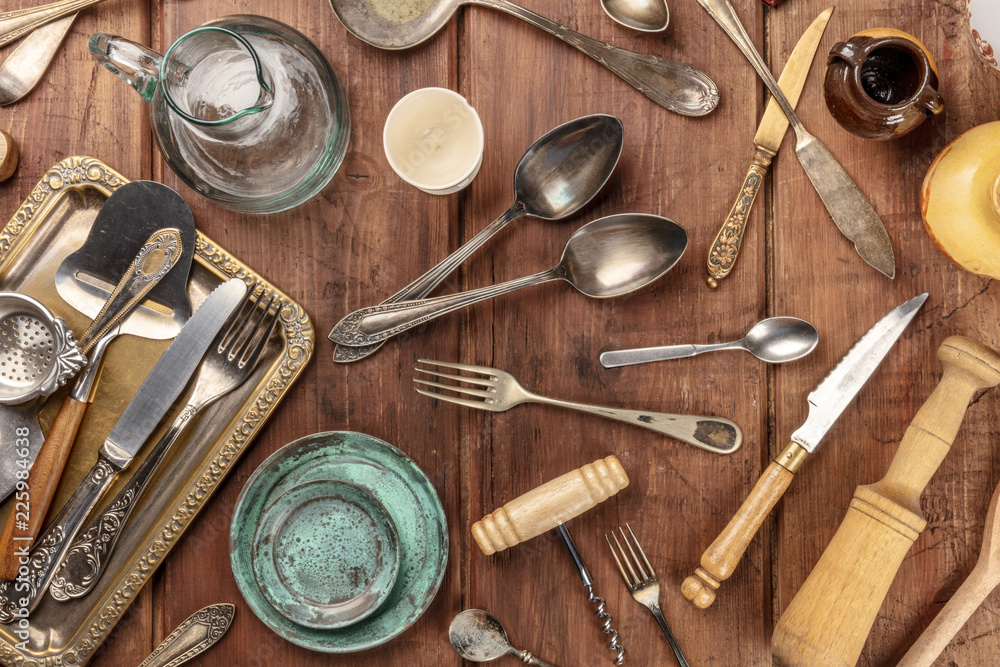 An overhead photo of many vintage kitchen objects and cutlery from an ...