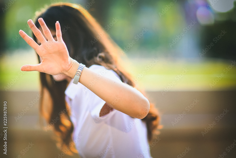 Girl show hand up, symbol of stop. invisible face, a young girl with ...