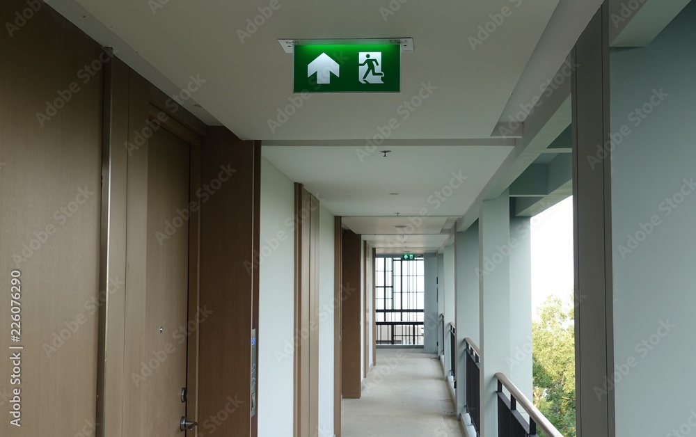 emergency fire exit sign direction to doorway in the building green ...
