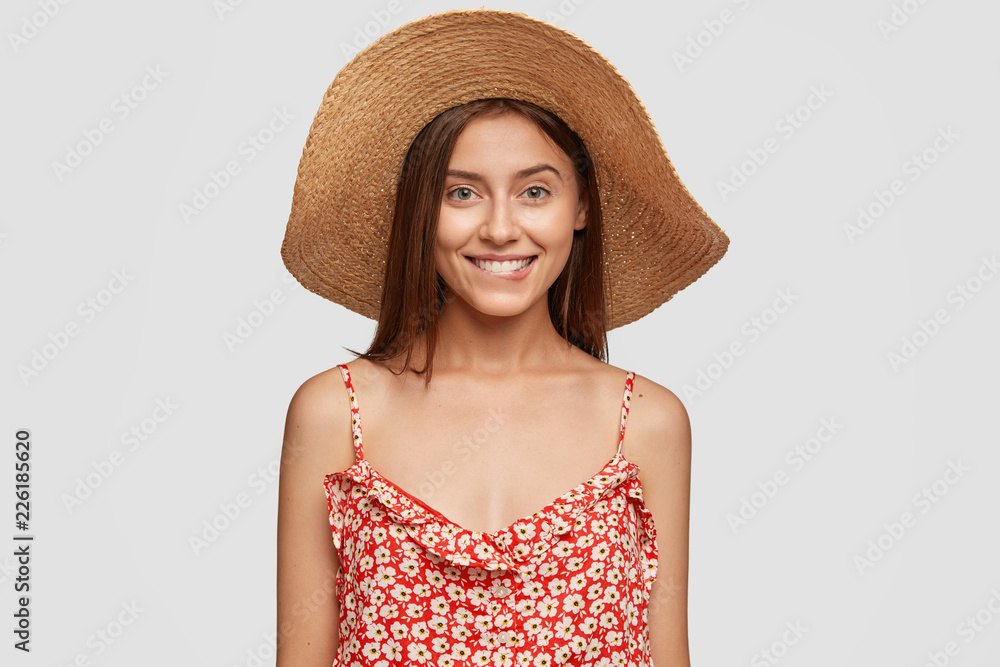 Horizontal shot of comely girlfriend with satisfied expression, bites ...