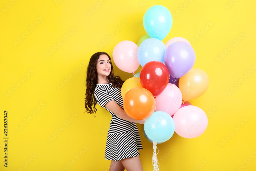 Cute girl with colored balloons on yellow background Stock Photo ...
