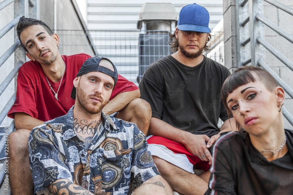 group of young rappers posing sitting on the metal stairs Stock Photo ...