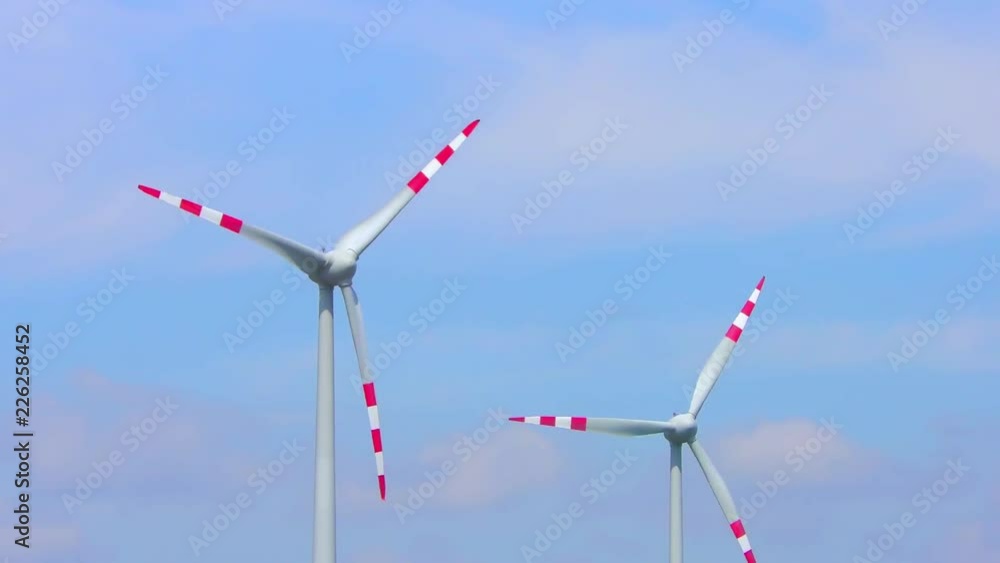 4K footage of wind turbines (aerofoil-powered generators) creating ...