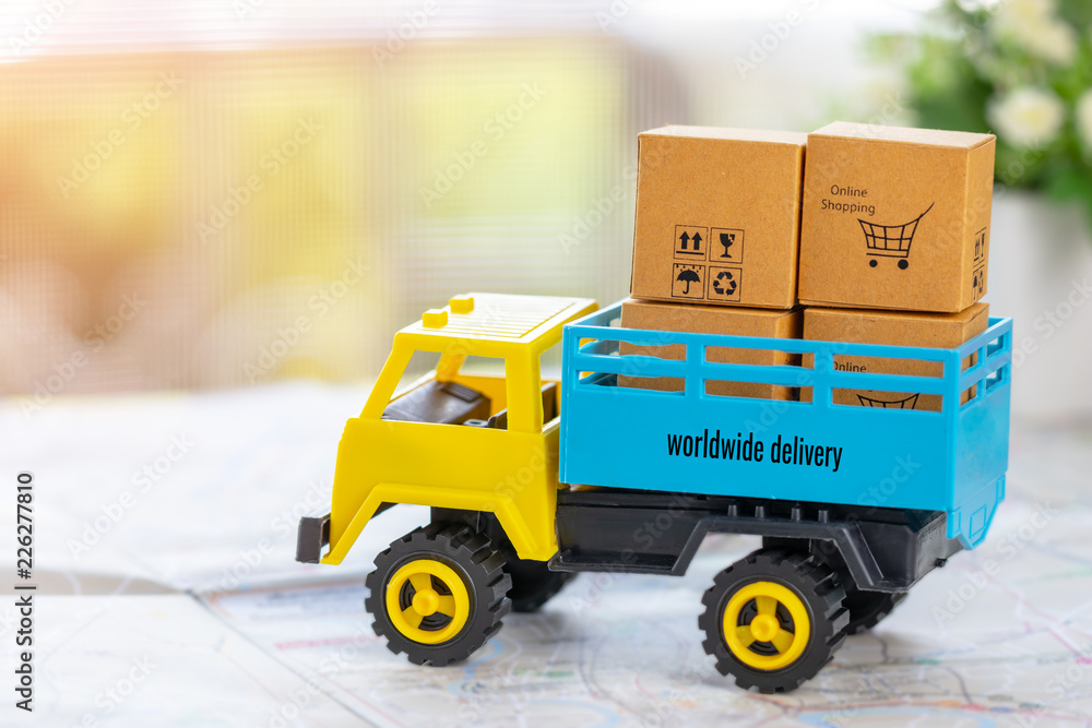 Transport truck with cardboard box with symbols, shopping cart, up ...