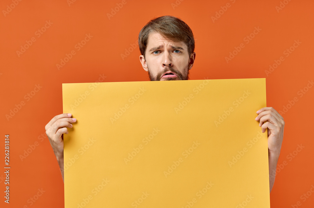 sad man holding yellow mockup Stock Photo | Adobe Stock