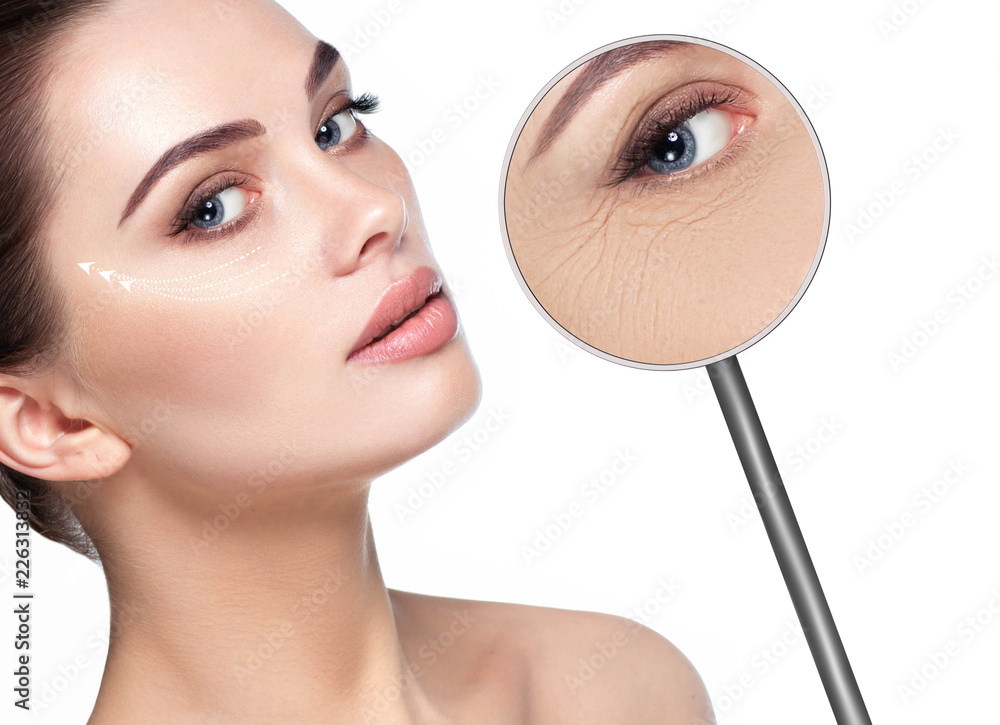 beautiful woman face with lifting arrows on skin and magnifying glass ...