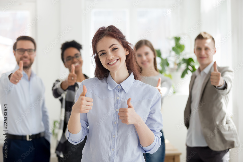 Happy girl with group of multiracial millennial positive businesspeople ...