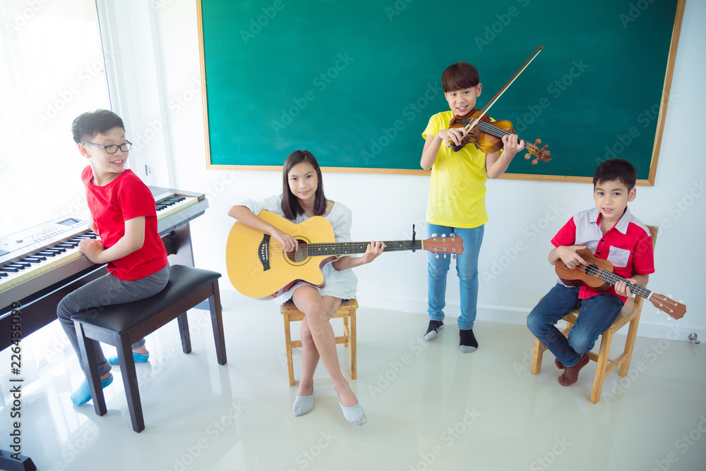 Group of happy Asian kids playing Music Instruments and smile In School ...
