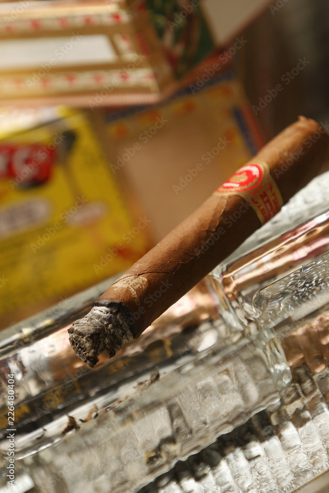 Cuban cigar box and person smoking cigar. Habano cigar wrapper is a ...