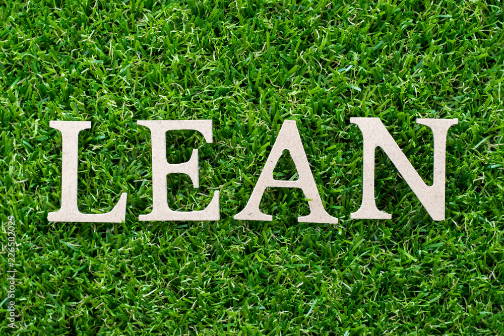 Wood letter in word lean on artificial green grass background Stock ...