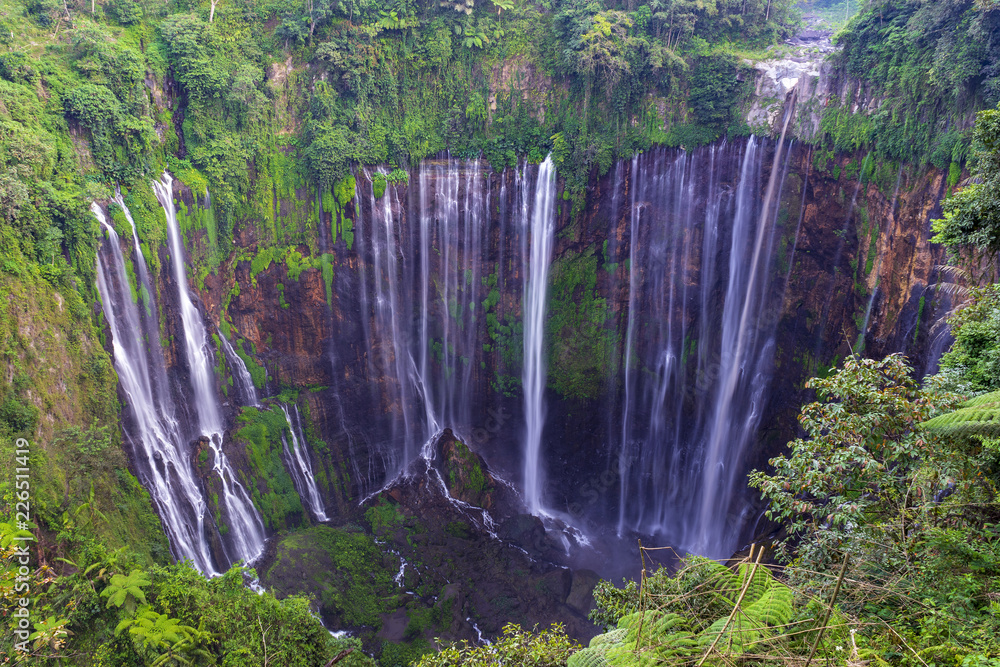 Majestic view of Tumpak Sewu Waterfall or also known as Coban Sewu, is ...