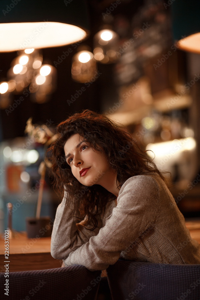 Cute woman having sleepy expression looking tired holding her hand on ...