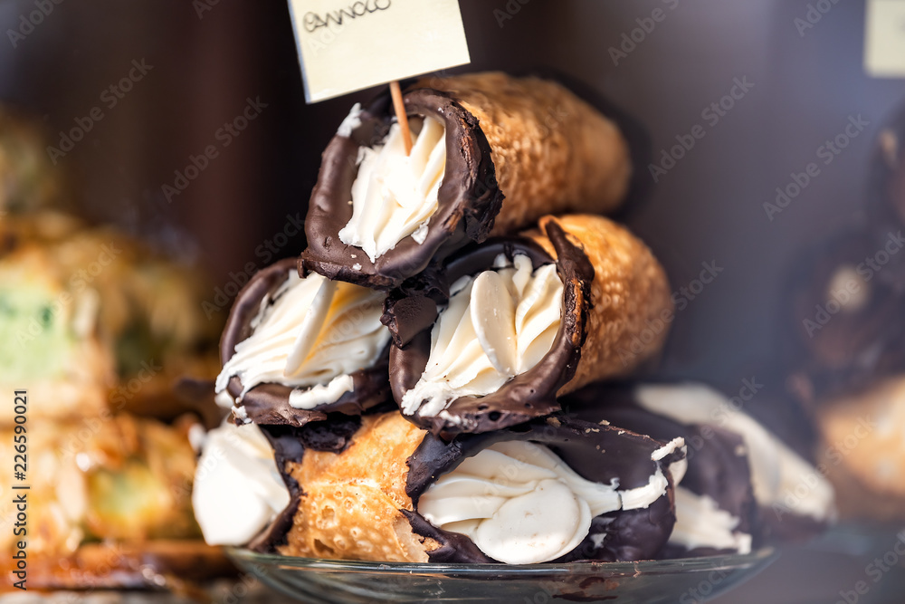Closeup of chocolate cannoli stuffed with cream cheese whipped filling ...