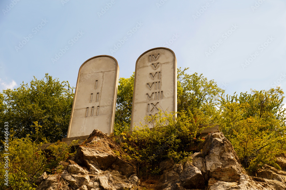 Ten Commandments List. Stone tablets on a rocky hill with carved 10 ...