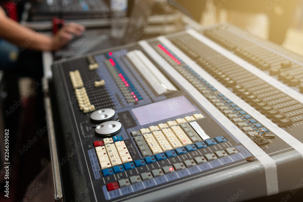 Close up of the rows of knobs and sliders on an analogue mixing console ...