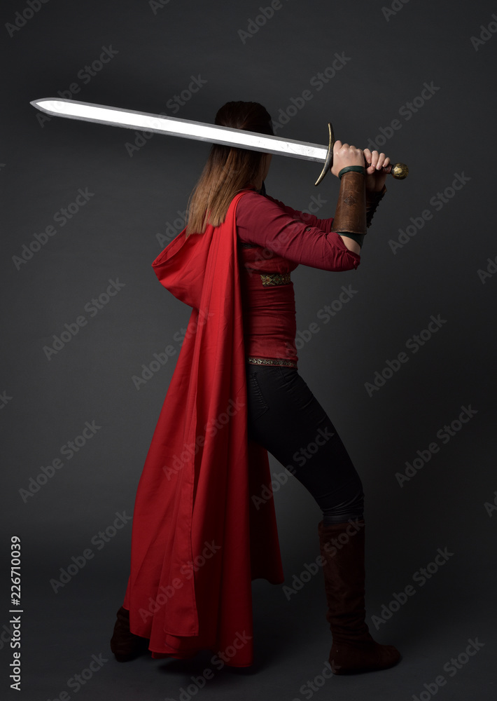 full length portrait of brunette girl wearing red medieval costume and ...